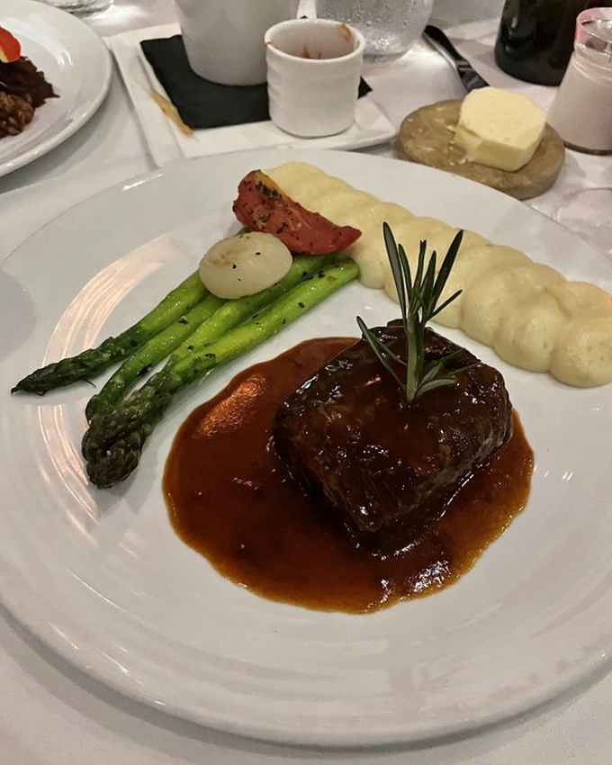 Short ribs so tender they practically surrender at the sight of your fork, swimming in a sauce you'll want to bottle and take home.