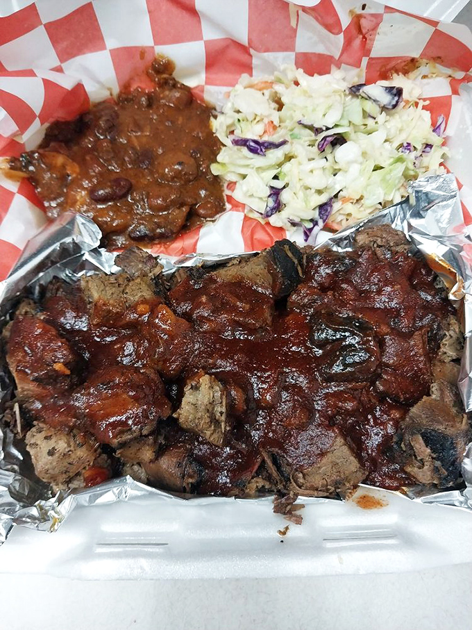 BBQ alchemy: beans, slaw, and meat transformed into a holy trinity of smoky satisfaction on a humble tray.