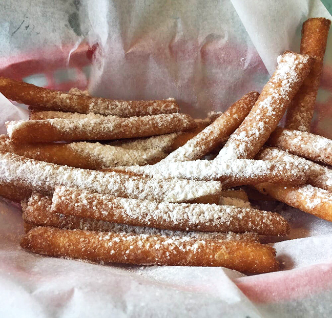 Beignet sticks dusted with powdered sugar &ndash; Louisiana's answer to churros and a sweet alternative when you can't decide between breakfast and dessert.