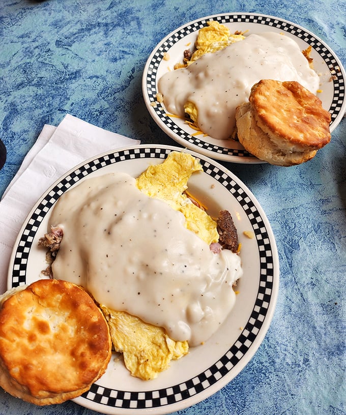 Two plates of heaven&mdash;where gravy doesn't just cover the food, it becomes one with it. Biscuits standing by for the delicious reunion.