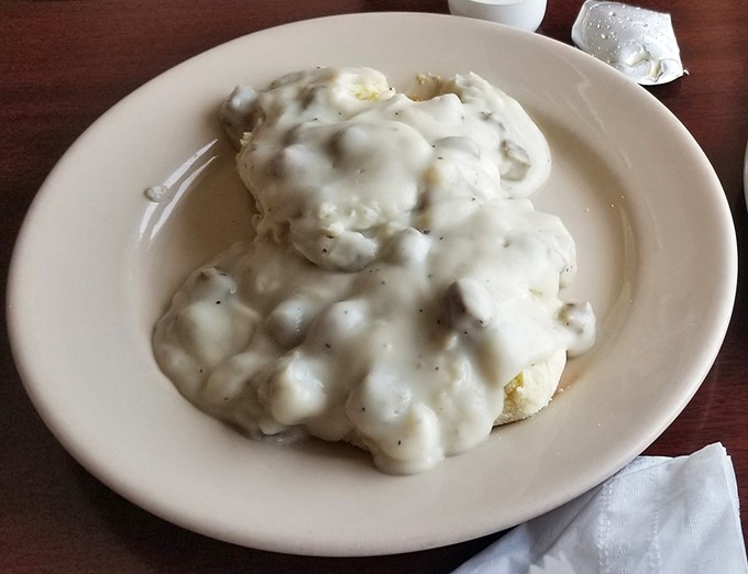 Biscuits drowning happily in pepper-flecked gravy, proving that sometimes more really is more in the best possible way.