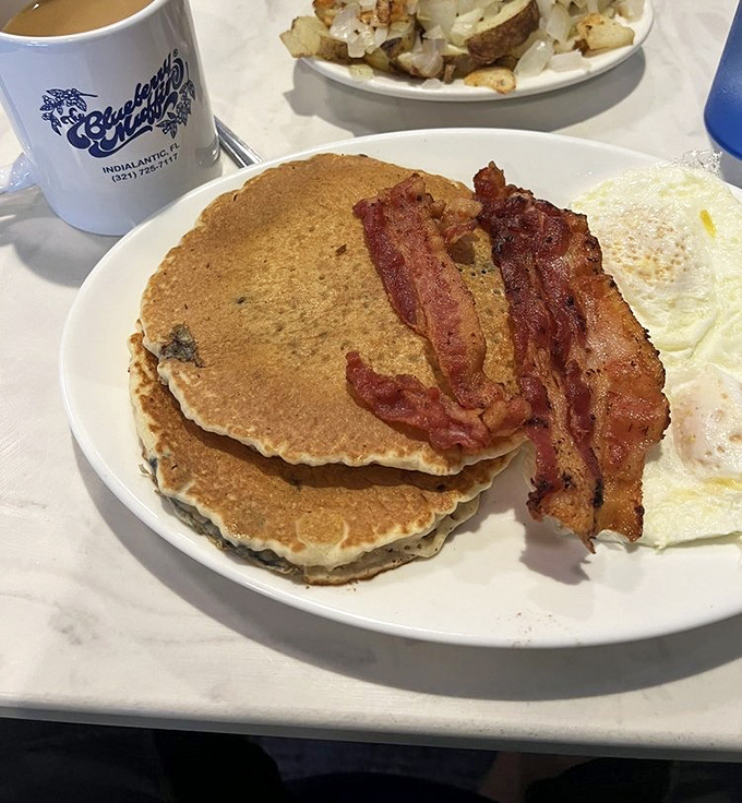 Blueberry pancakes with crispy bacon and eggs&mdash;the breakfast trinity that's converted more night owls to morning people than all the alarm clocks in Florida.
