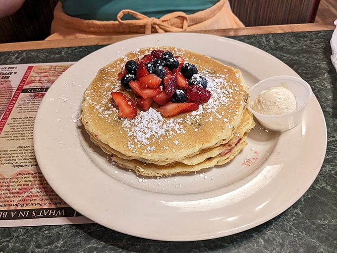 Pancakes adorned with fresh berries and powdered sugar&mdash;the breakfast equivalent of putting on your Sunday best. Simple perfection on a plate.