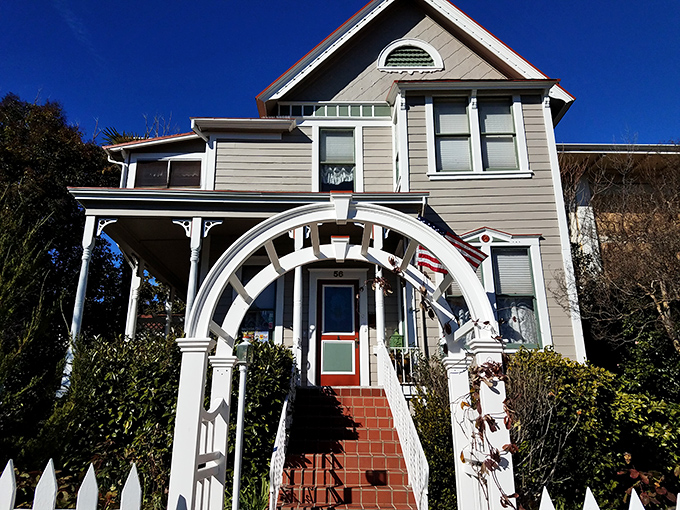Victorian elegance meets garden paradise at this historic home where roses climb and bloom with wild abandon.