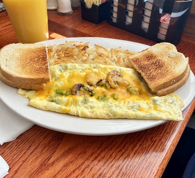 This omelet doesn't just contain ingredients&mdash;it showcases them, like a Broadway production where eggs, cheese, and perfectly crisped hash browns all deserve standing ovations.