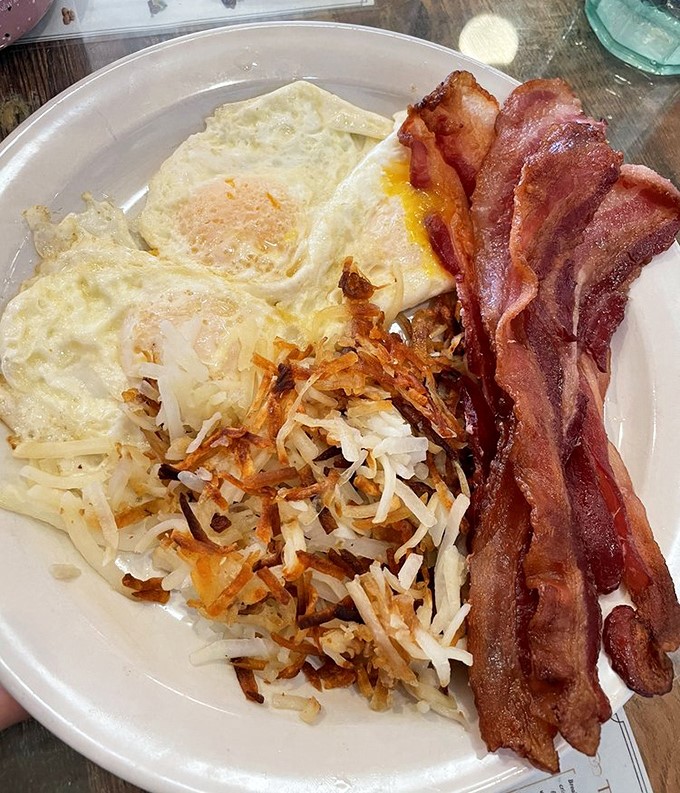 Breakfast perfection: crispy hash browns, farm-fresh eggs, and bacon that would make Ron Swanson weep with joy. The holy trinity of morning deliciousness, Arizona-style. 