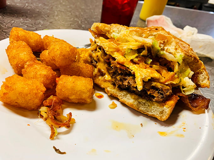 The legendary Clover Grill burger in all its glory, paired with golden tater tots &ndash; a perfect combination of diner indulgence.