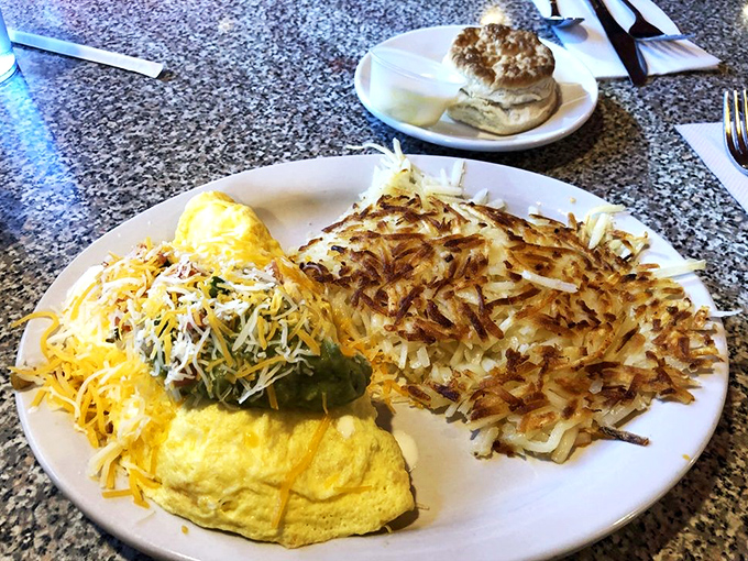 Breakfast perfection on a plate&mdash;a cheese-laden omelet alongside hash browns so perfectly crispy they deserve their own gold record in the comfort food hall of fame.