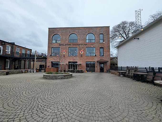 This brick building houses Briquettes Smokehouse, where architectural history meets culinary present. The circular courtyard begs for summer evening gatherings.
