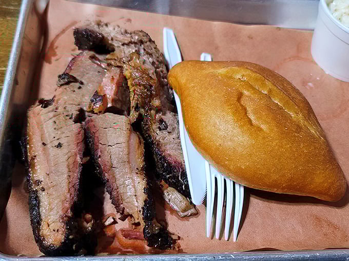 Brisket sliced thicker than a Southern accent, with that telltale pink smoke ring that whispers, "I've been cooking since yesterday, just for you."