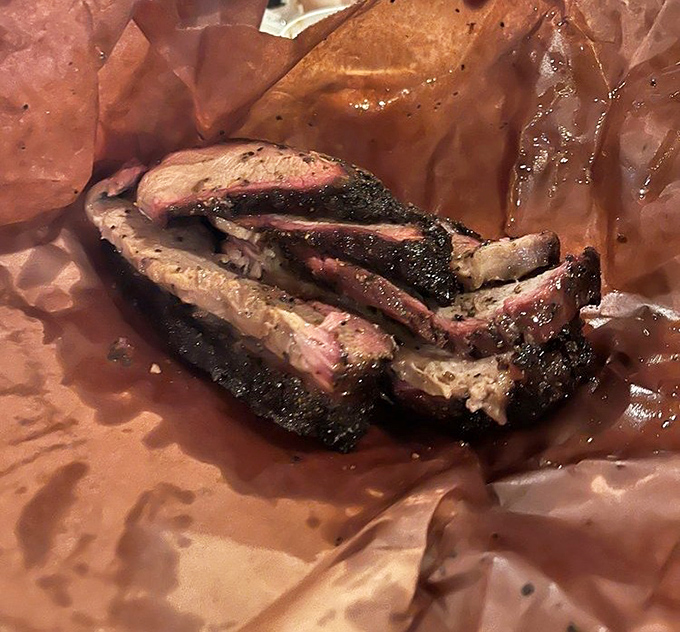 The brisket's pink smoke ring isn't just photogenic&mdash;it's the BBQ equivalent of a Grammy lifetime achievement award for patience and wood-fire mastery.