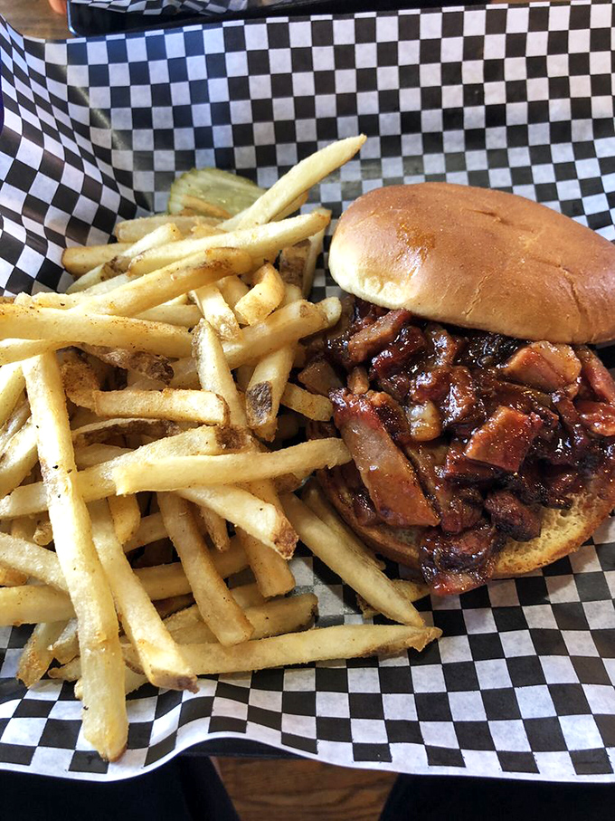 The brisket sandwich towers majestically, proving that sometimes the best things in life require two hands and zero dignity.