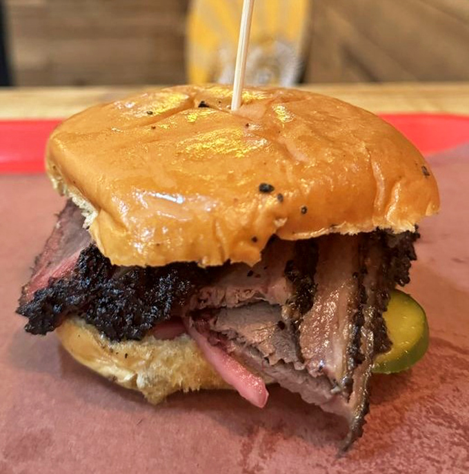 This isn't just a sandwich; it's an architectural marvel of smoked meat engineering that demands both reverence and napkins.