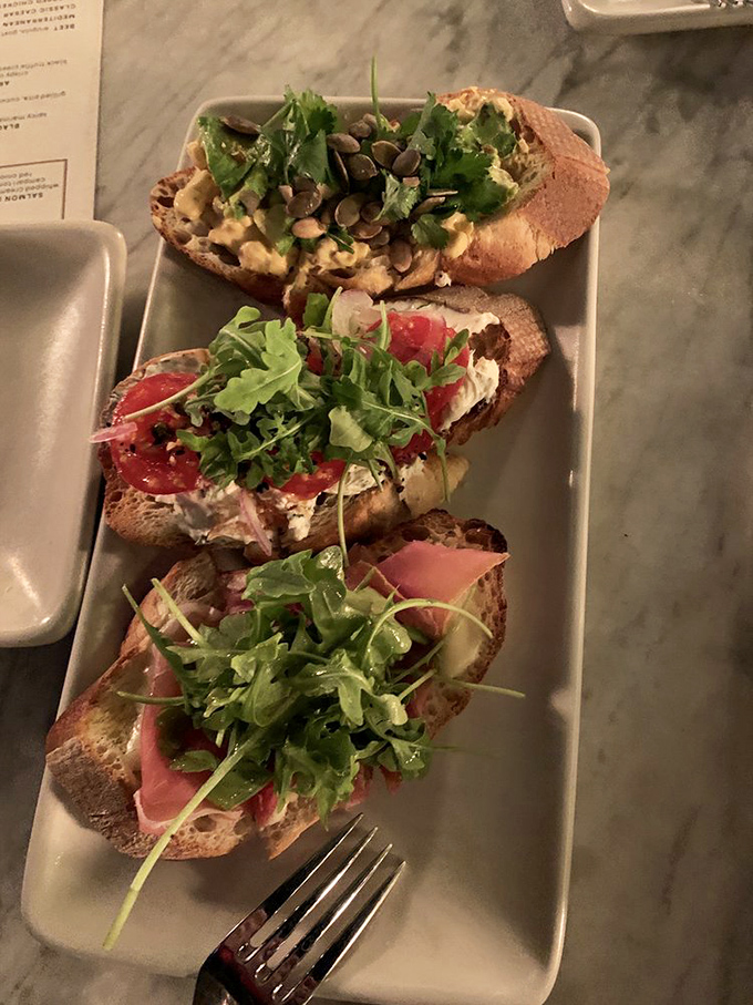 Bruschetta that demands to be photographed before eaten. The arugula's practically doing a victory dance atop these flavor-packed slices.