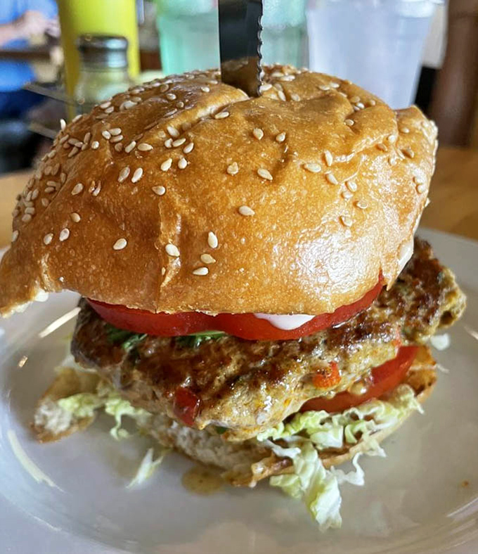 Bacon, cheese, and sesame-studded glory stacked so high it defies the laws of burger physics entirely.