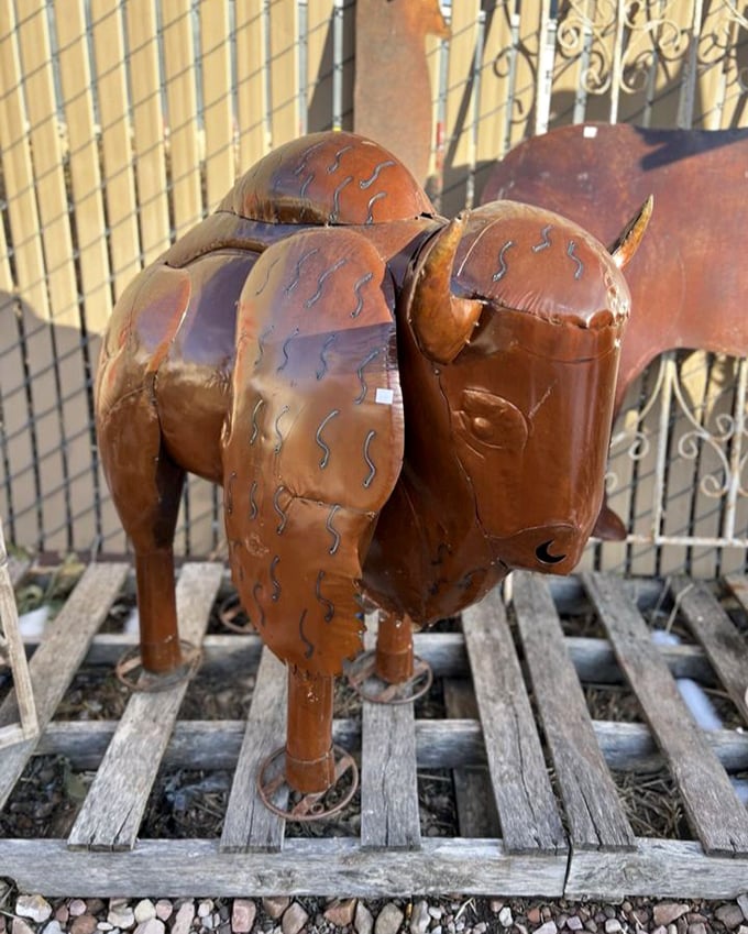 This copper buffalo sculpture stands guard outside, a metallic sentinel welcoming treasure hunters to the wild west of antiquing.