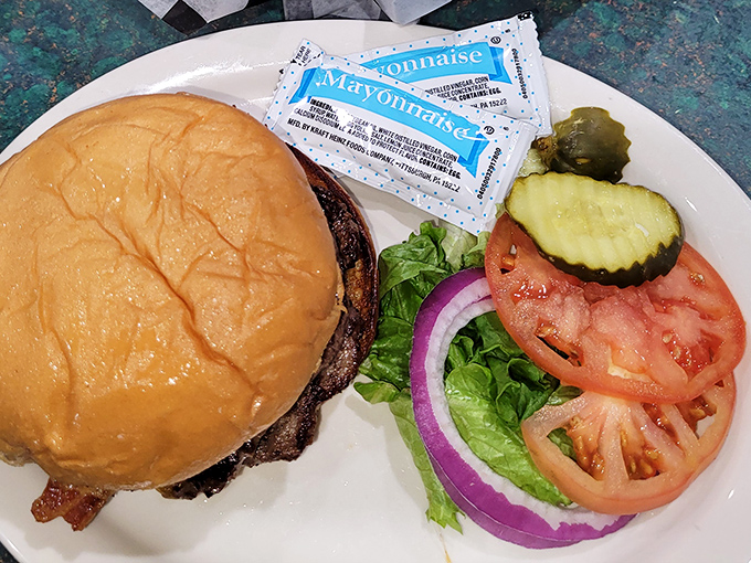 A proper diner burger comes with proper fixings&mdash;crisp lettuce, ripe tomato, and a pickle that's practically begging to be the first bite.
