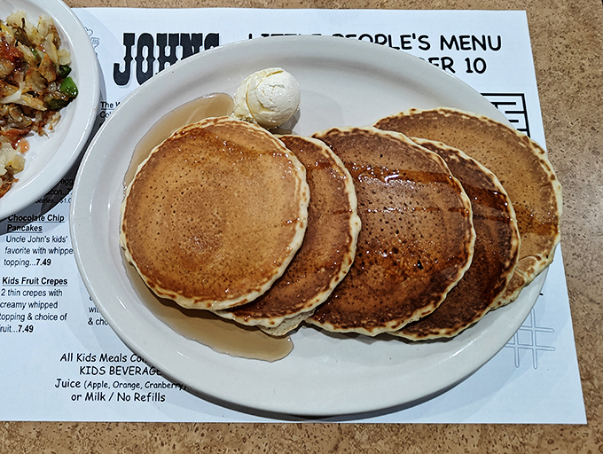 These golden-brown pancakes aren't just breakfast, they're edible sunshine with a pat of butter melting like a morning snowflake.