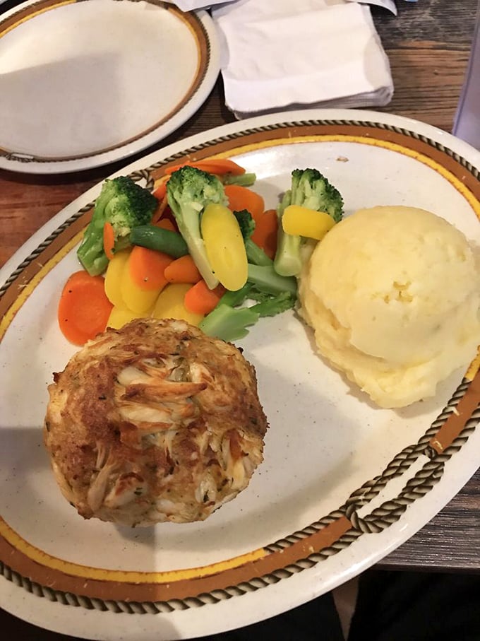 That golden crab cake sits pretty next to creamy mashed potatoes &ndash; Maryland comfort food at its finest.