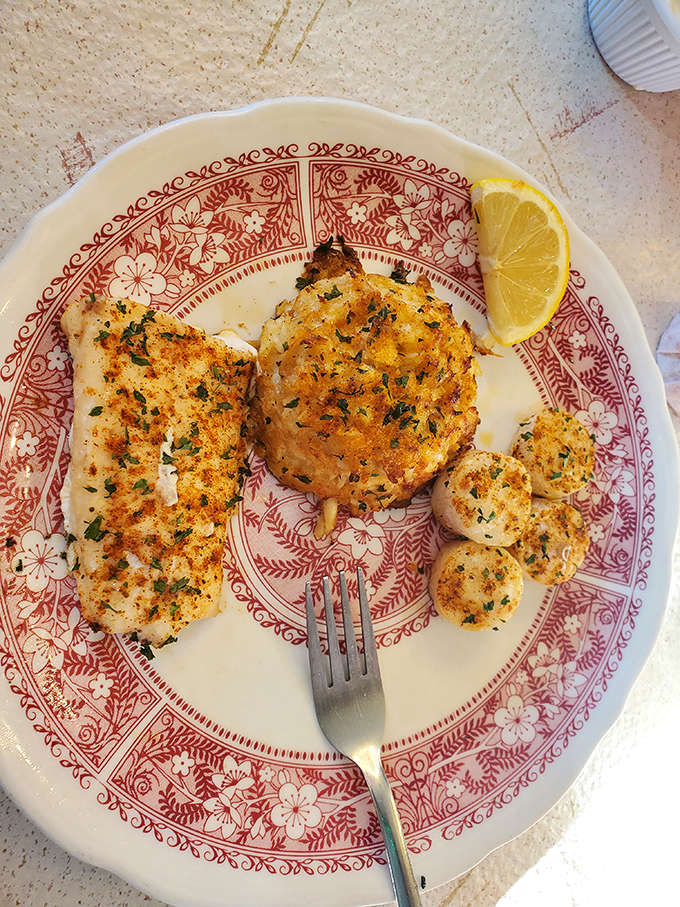 The seafood combination plate showcases golden-brown crab cake, perfectly broiled fish, and scallops that taste like they're fresh from the ocean&mdash;despite being hours from the coast. 