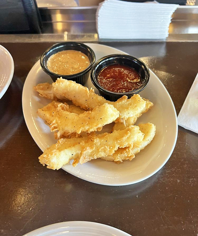 Crispy calamari that shatters with each bite, paired with dipping sauces that make you wonder why you'd ever share this plate.