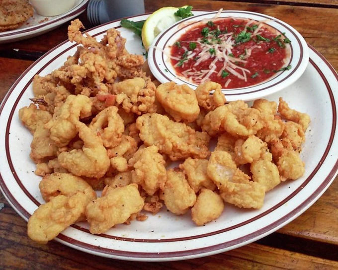 Fried calamari that defies the rubbery reputation of lesser versions. Crispy, tender, and ready for a dip in that marinara&mdash;seafood simplicity at its finest.