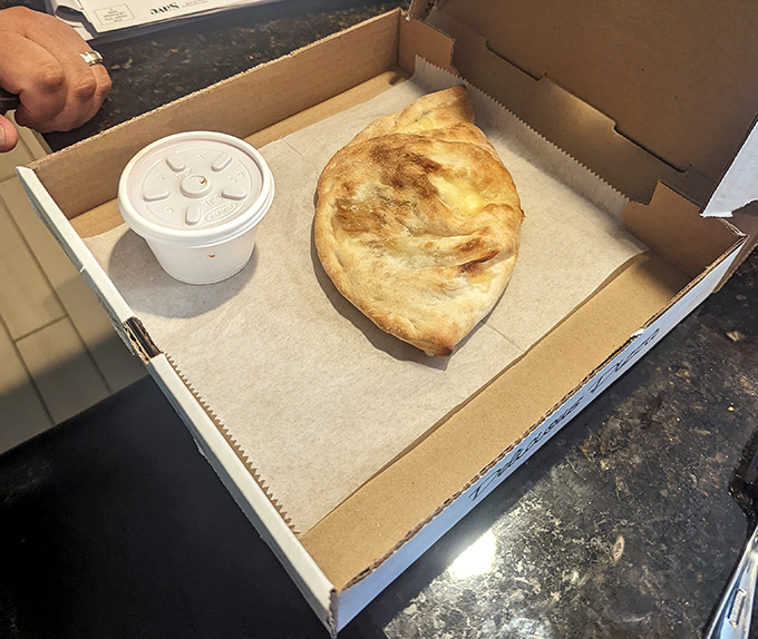 The calzone: pizza's introverted cousin that keeps all the good stuff tucked inside. That golden crust is the sleeping bag for cheese dreams.