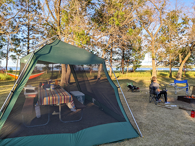 Camping perfection: where your screen time involves actual screens keeping bugs out while you enjoy lakeside serenity.