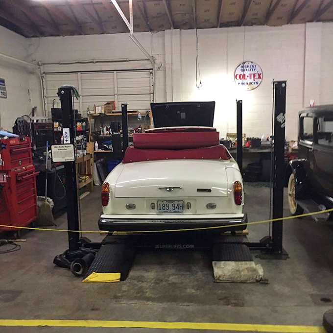 This classic convertible on a service lift reveals the museum isn't just about showing cars&mdash;it's about preserving automotive history from bumper to bumper.
