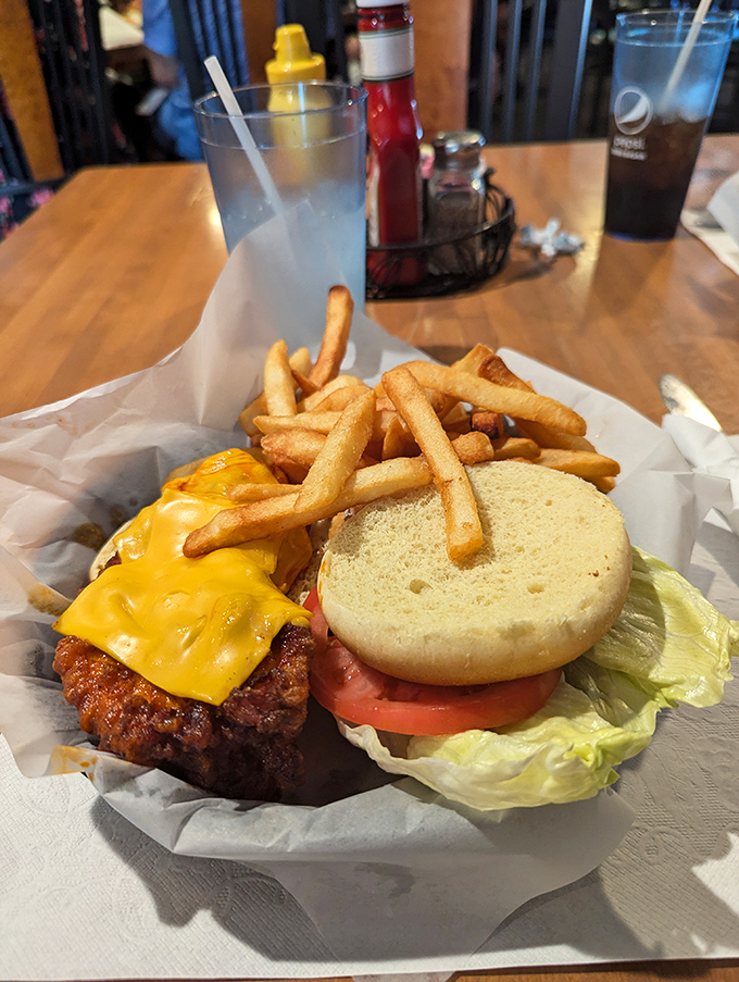 This isn't just a cheeseburger; it's a masterclass in American comfort food, with melted cheese cascading down the sides like a yellow waterfall.