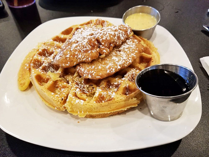 Crispy fried chicken meets Belgian waffles in this sweet-and-savory masterpiece dusted with powdered sugar and drizzled with syrup perfection.