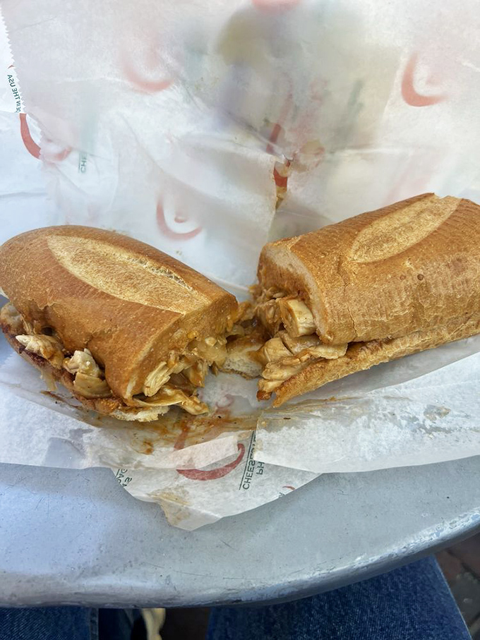 The chicken cheesesteak cut in half reveals its secrets &ndash; juicy meat, melted cheese, and that bread that somehow stays sturdy despite the delicious onslaught.