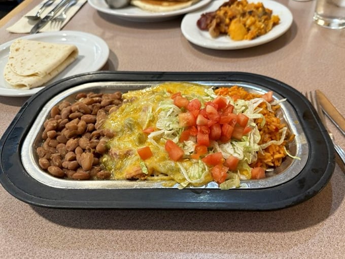 Chicken enchiladas smothered in cheese and chile &ndash; the kind of plate that makes you want to cancel your afternoon plans for a well-deserved siesta. 