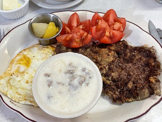 Chicken fried steak with country gravy&mdash;where crispy, savory coating meets tender meat in a dish that whispers "comfort" with every bite.