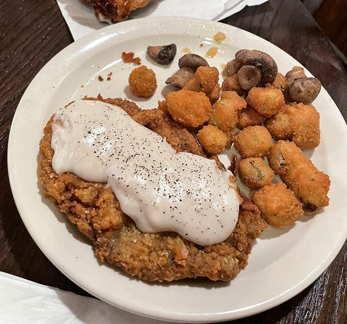 Country-fried steak smothered in pepper gravy alongside golden-fried okra&mdash;a plate that says "Welcome to the South" more clearly than any roadside sign.