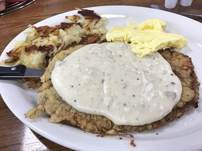 Country fried steak smothered in peppery gravy – the kind of breakfast that makes you want to cancel your other meals for the day.