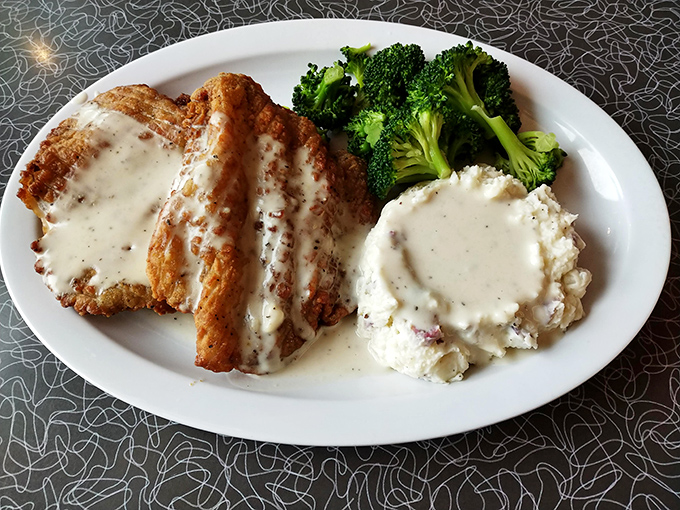 Chicken fried steak that's crispy on the outside, tender within, and swimming in that legendary country gravy. The side of mashed potatoes isn't jealous&mdash;it's getting the same royal treatment.