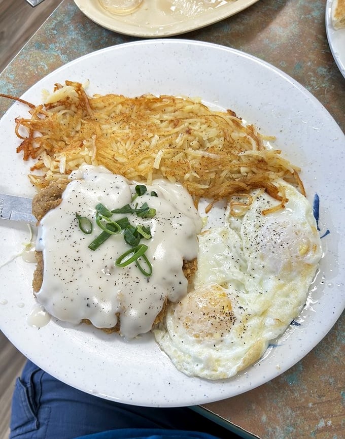Crispy hash browns, eggs cooked just right, and gravy that should be illegal &ndash; this plate doesn't just feed you, it hugs you from the inside.
