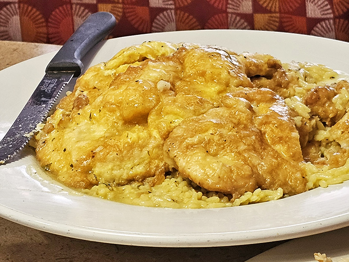 Golden chicken nestled on a bed of rice, smothered in a sauce that's asking to be sopped up with every available carb within reach.