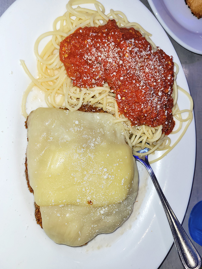 This chicken parm isn't messing around &ndash; melted cheese cascading over perfectly breaded cutlets atop a mountain of spaghetti.