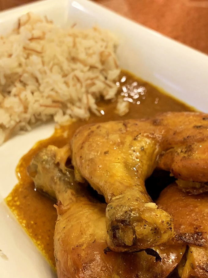 The chicken tagine arrives like royalty on a bed of rice, swimming in a sauce that's been perfecting itself for centuries.