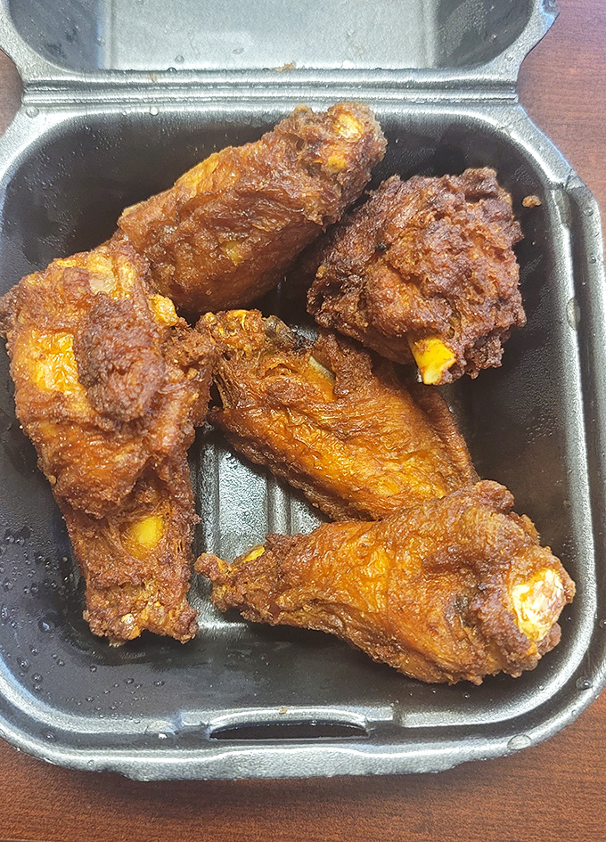 These wings aren't just fried; they're transformed into crispy vessels of joy that would make even the most dignified person lick their fingers in public.