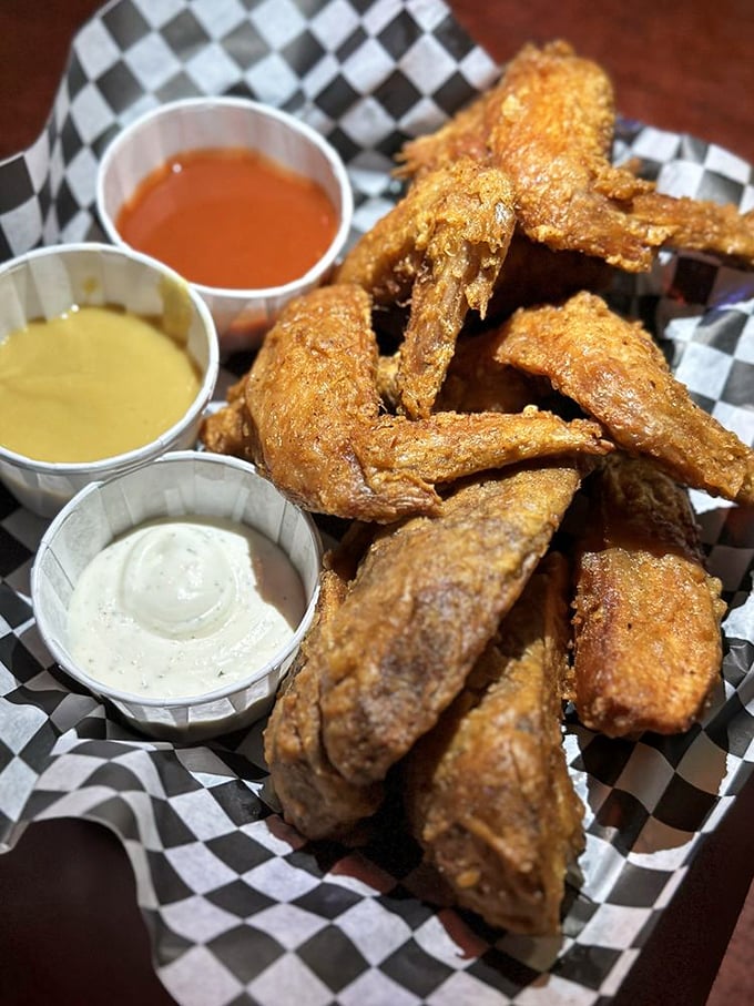 Wings so perfectly fried they should be in the Smithsonian. Three dipping sauces because life's too short for just one flavor experience.