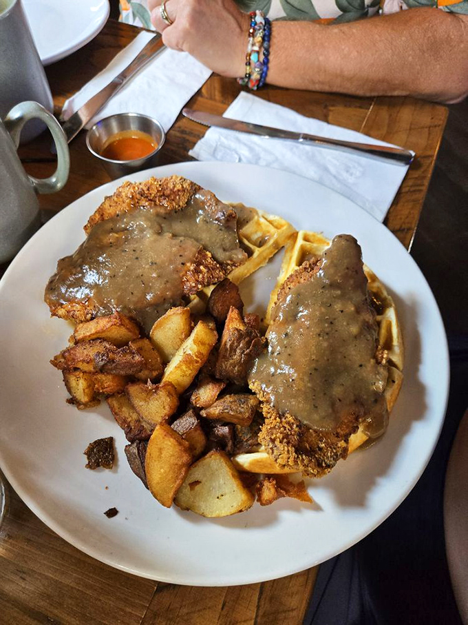 Chicken and waffles swimming in sausage gravy&mdash;where breakfast and dinner collide in the most delicious custody battle imaginable.