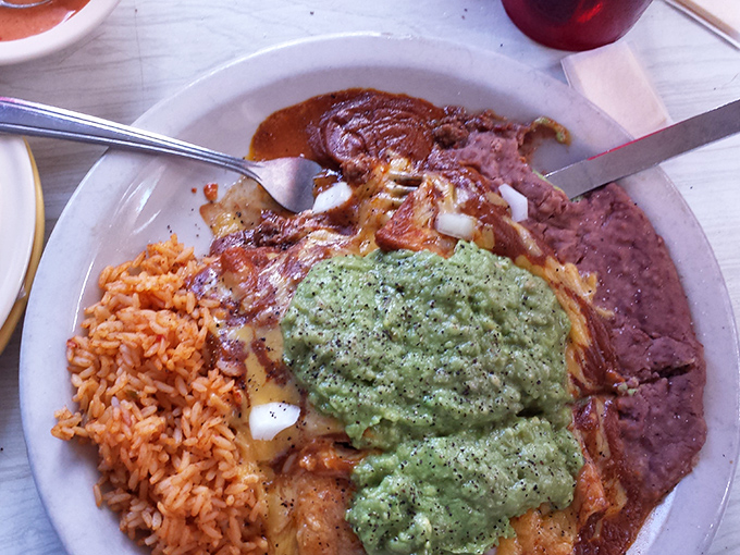 A plate that tells the whole Texas story: Spanish influence, Mexican soul, and American abundance, all smothered in guacamole that's greener than springtime.