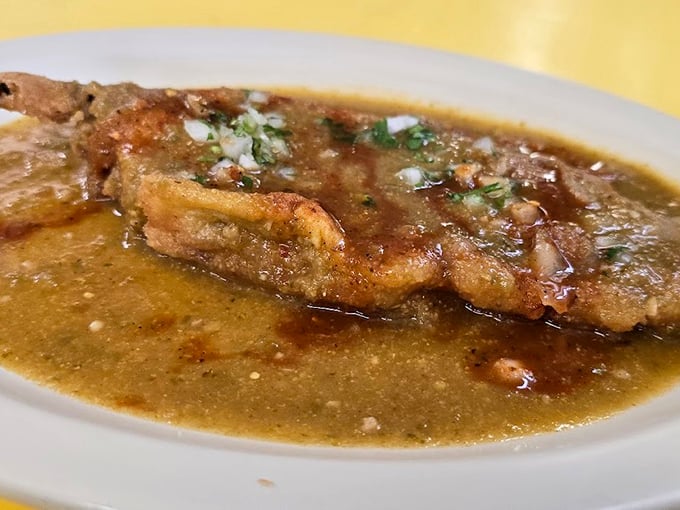 The chile relleno swimming in green sauce isn't just food&mdash;it's edible architecture, a masterclass in texture where crispy batter meets tender pepper meets molten cheese.