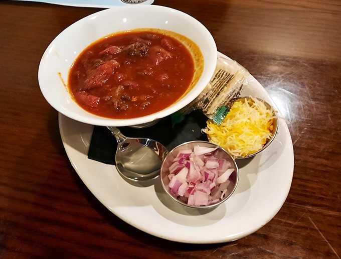 This isn't just chili—it's a hearty bowl of Midwest comfort with all the fixings standing by for your personal touch.