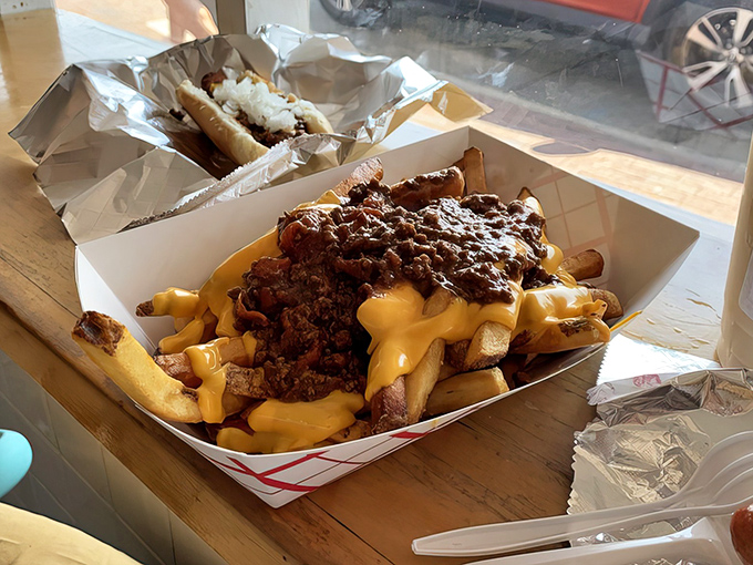Chili cheese fries that laugh in the face of diet culture. This glorious mess of crispy potatoes, savory chili, and molten cheese demands both napkins and respect.