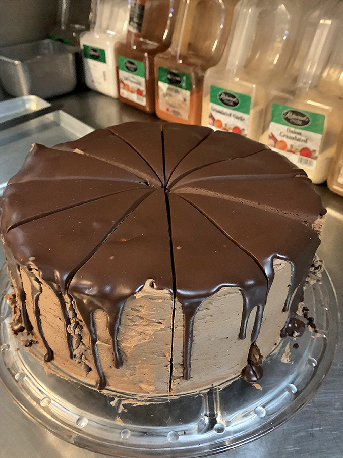 Chocolate cake so decadent it should require a permission slip. The ganache dripping down the sides is pure food poetry.