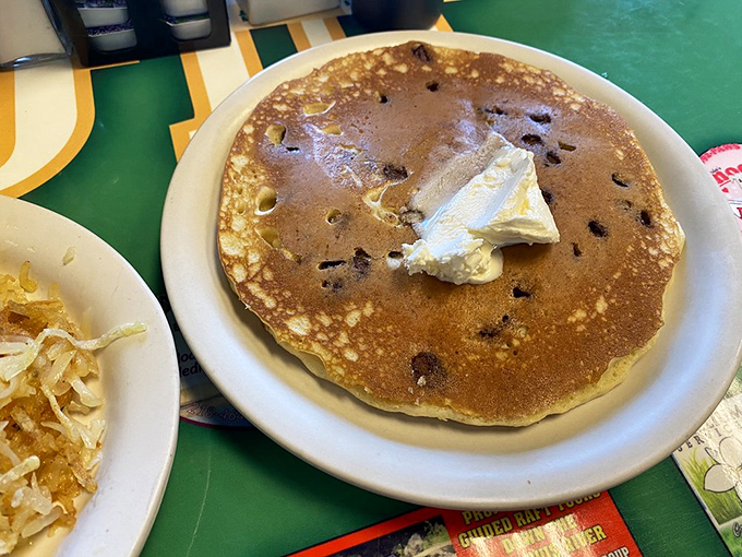 This blueberry pancake isn't just breakfast&mdash;it's a fluffy canvas of happiness with butter slowly melting into a warm pool of morning joy.